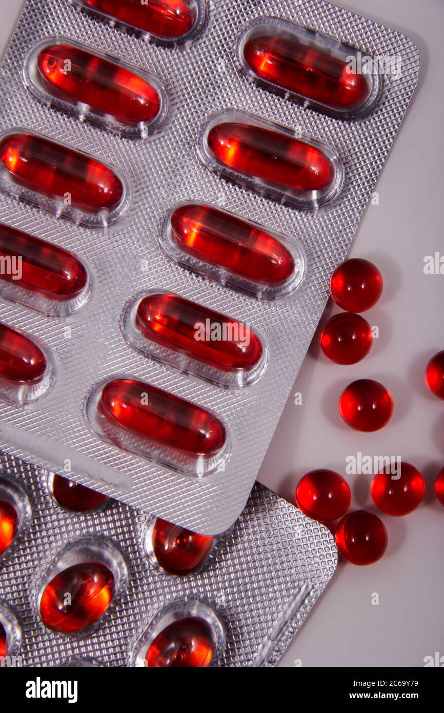 Pills and colored capsules are inside the package. Colored tablets and ...