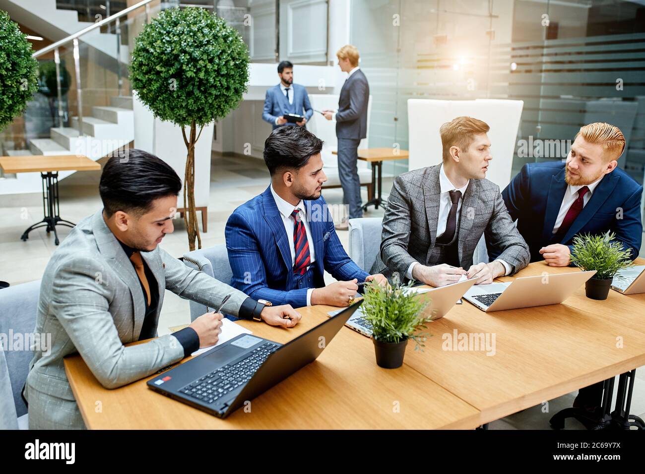 Smart and young men conduct negotiations in business office. Arabic ...