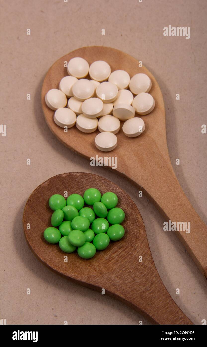 Colored tablets and capsules out of the cover. Arrange colored tablets ...