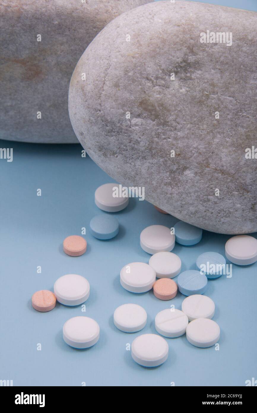 Colored tablets out of the package. Colored pills with a simple ...