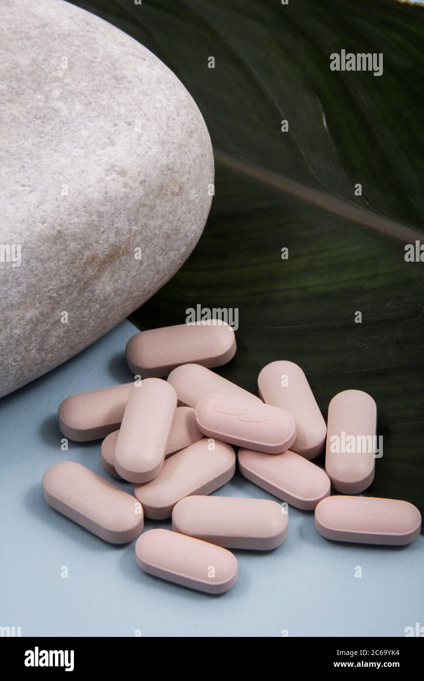 Some white capsules. Capsules together in one container or out of ...
