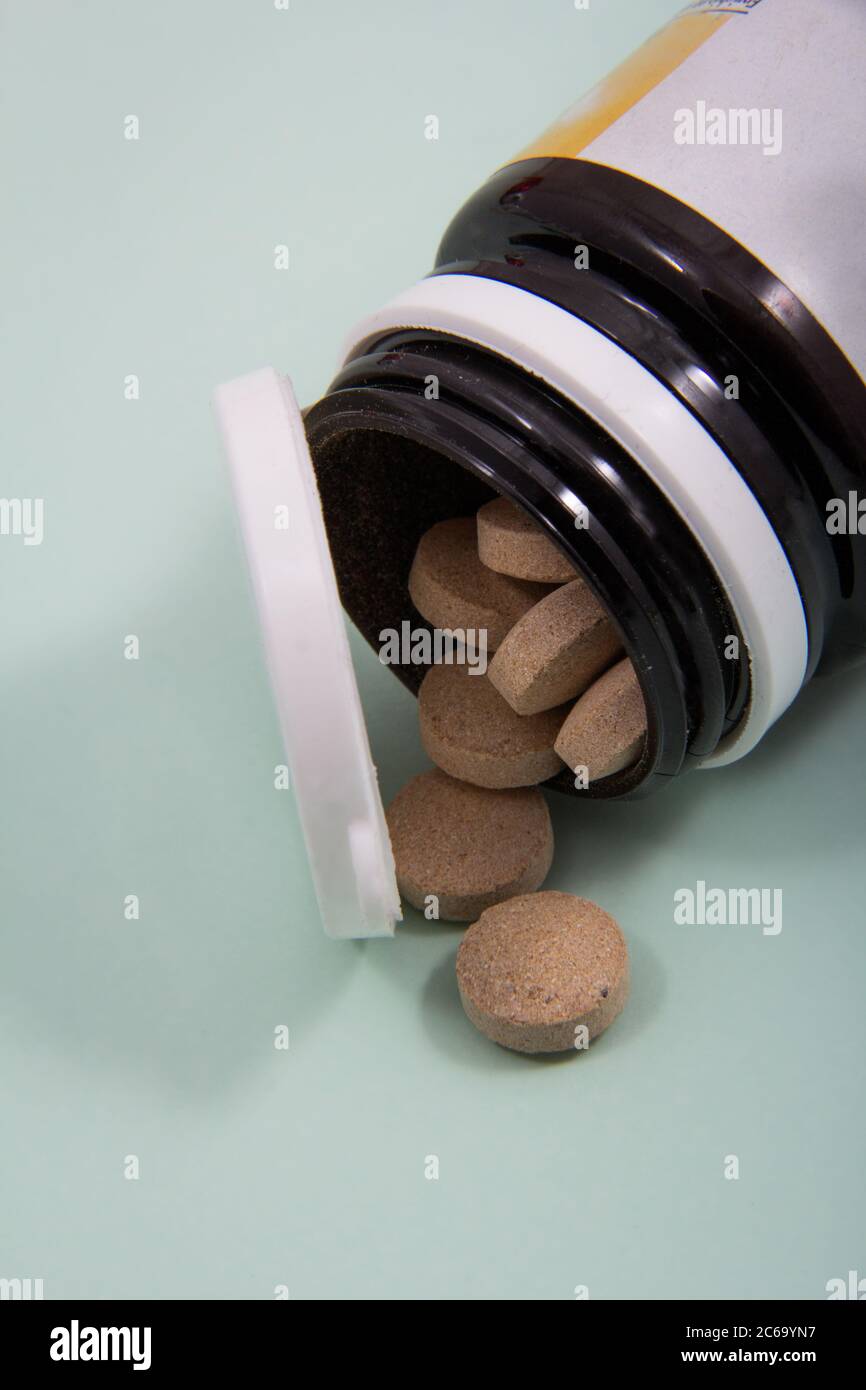 Colored tablets out of the package. Colored pills with a simple ...