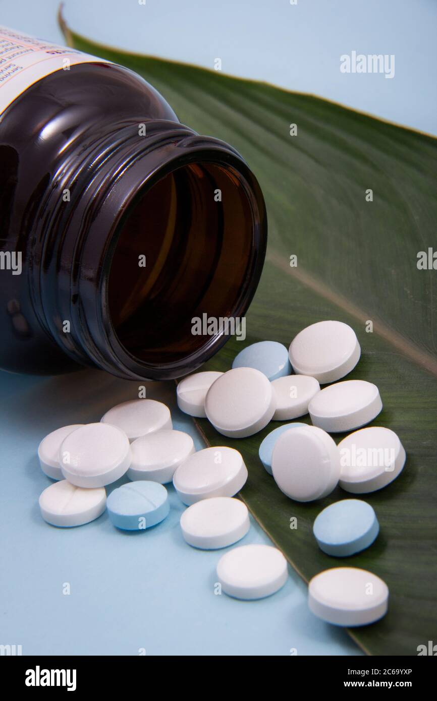 Colored tablets out of the package. Colored pills with a simple ...