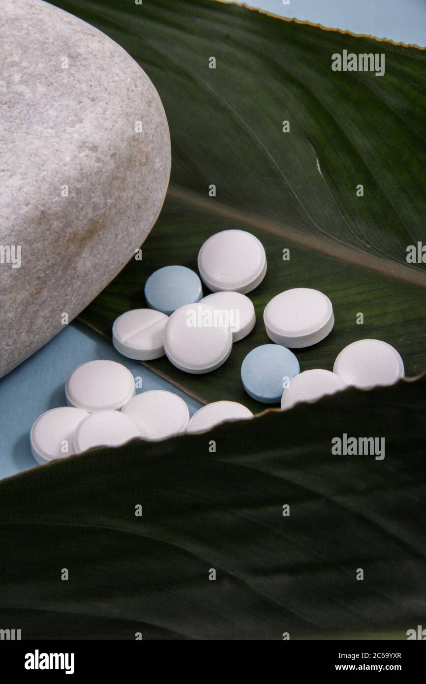 Colored tablets out of the package. Colored pills with a simple ...