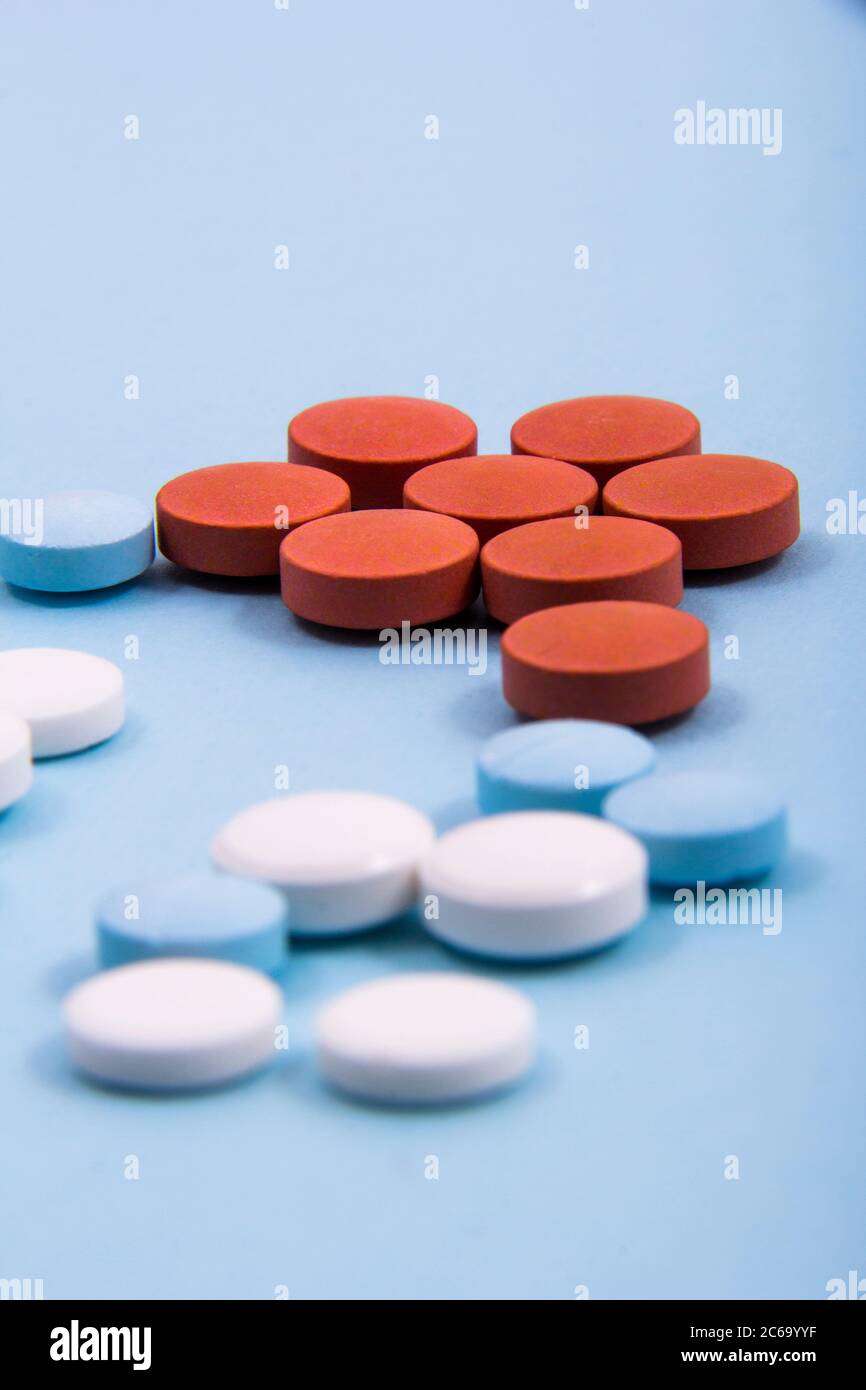 Colored tablets out of the package. Colored pills with a simple ...