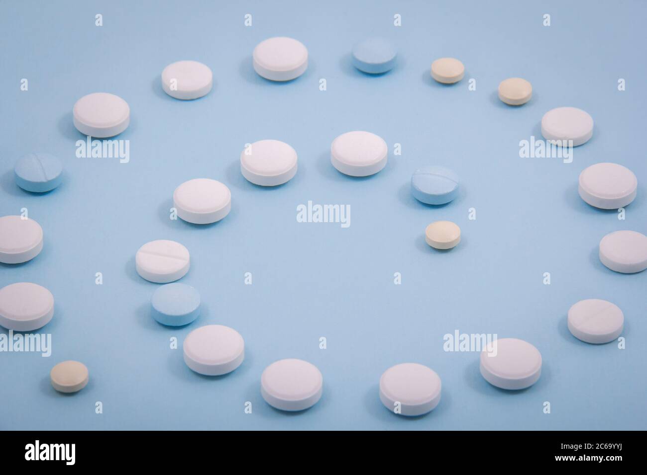 Colored tablets out of the package. Colored pills with a simple ...