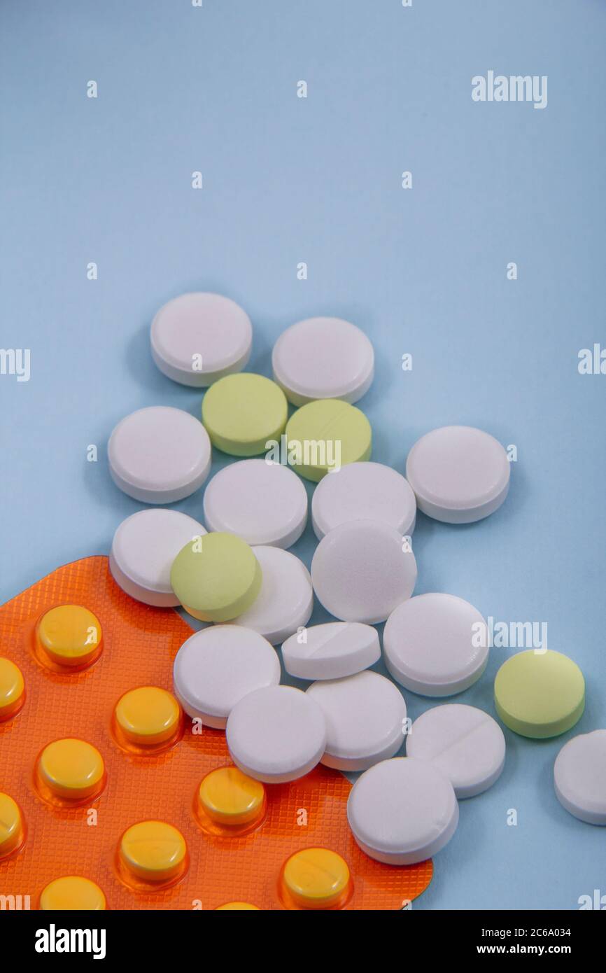 Colored tablets out of the package. Colored pills with a simple ...