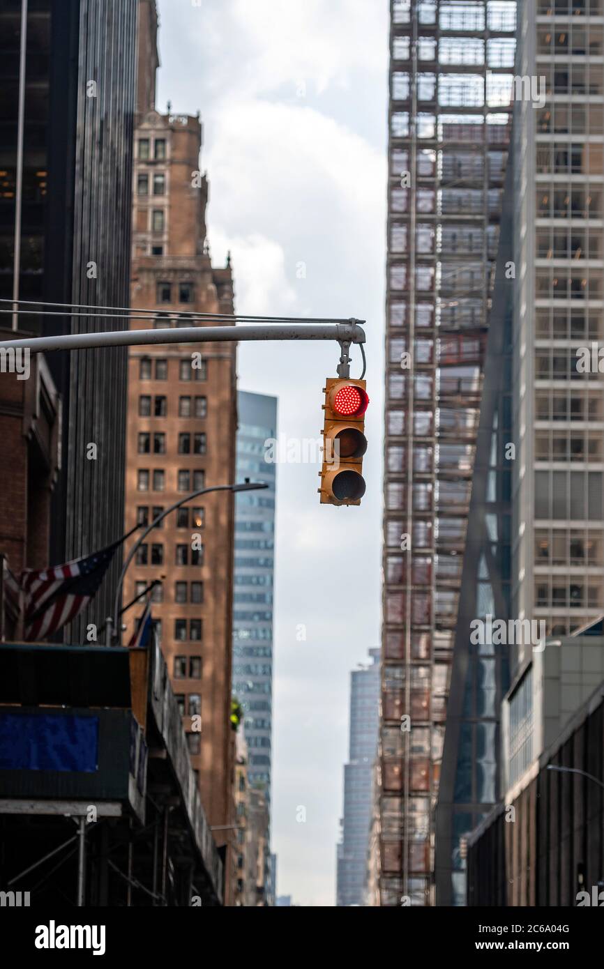 Traffic light with red light above Manhatan street among many ...