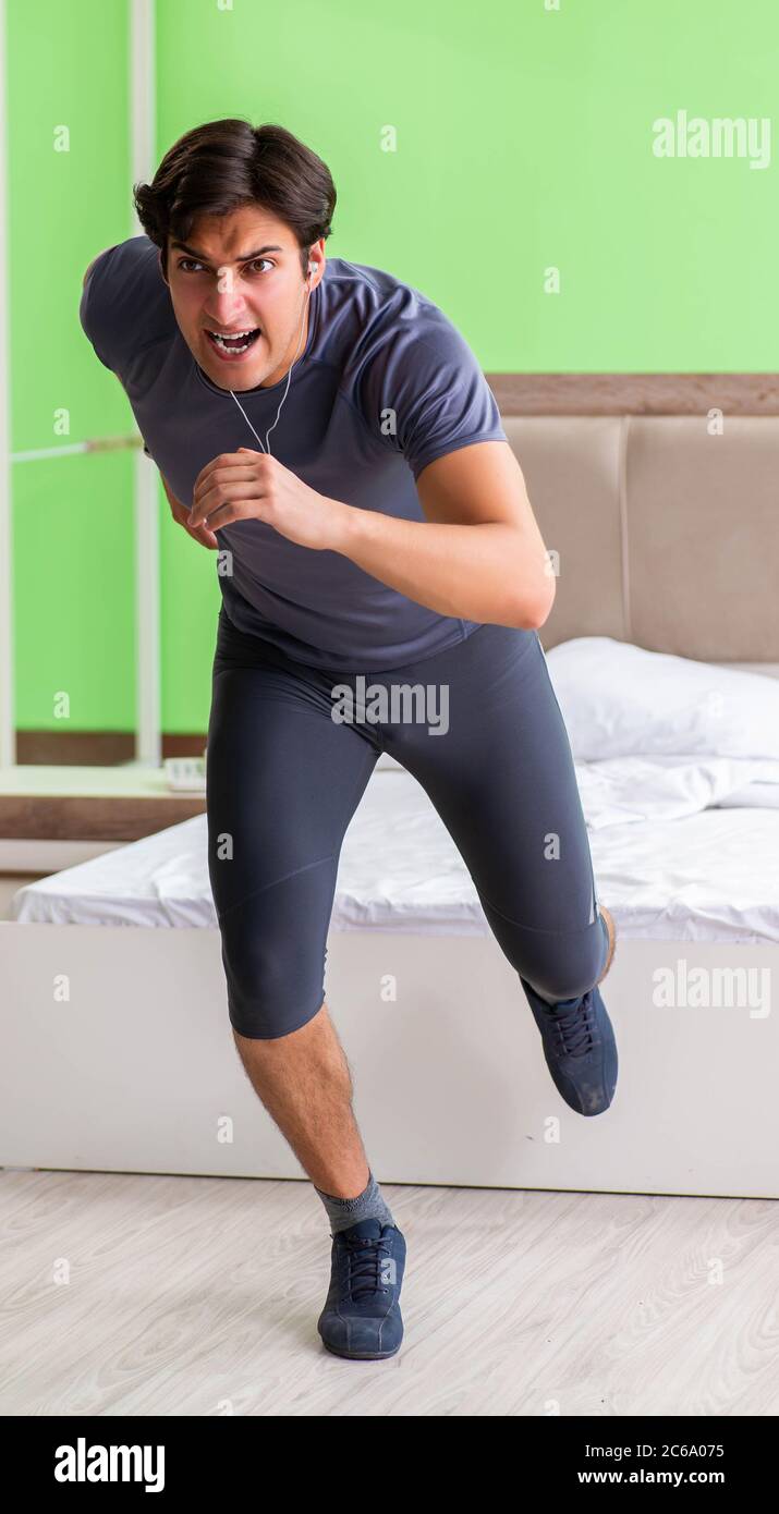 The young handsome man doing morning exercises in the hotel room Stock ...