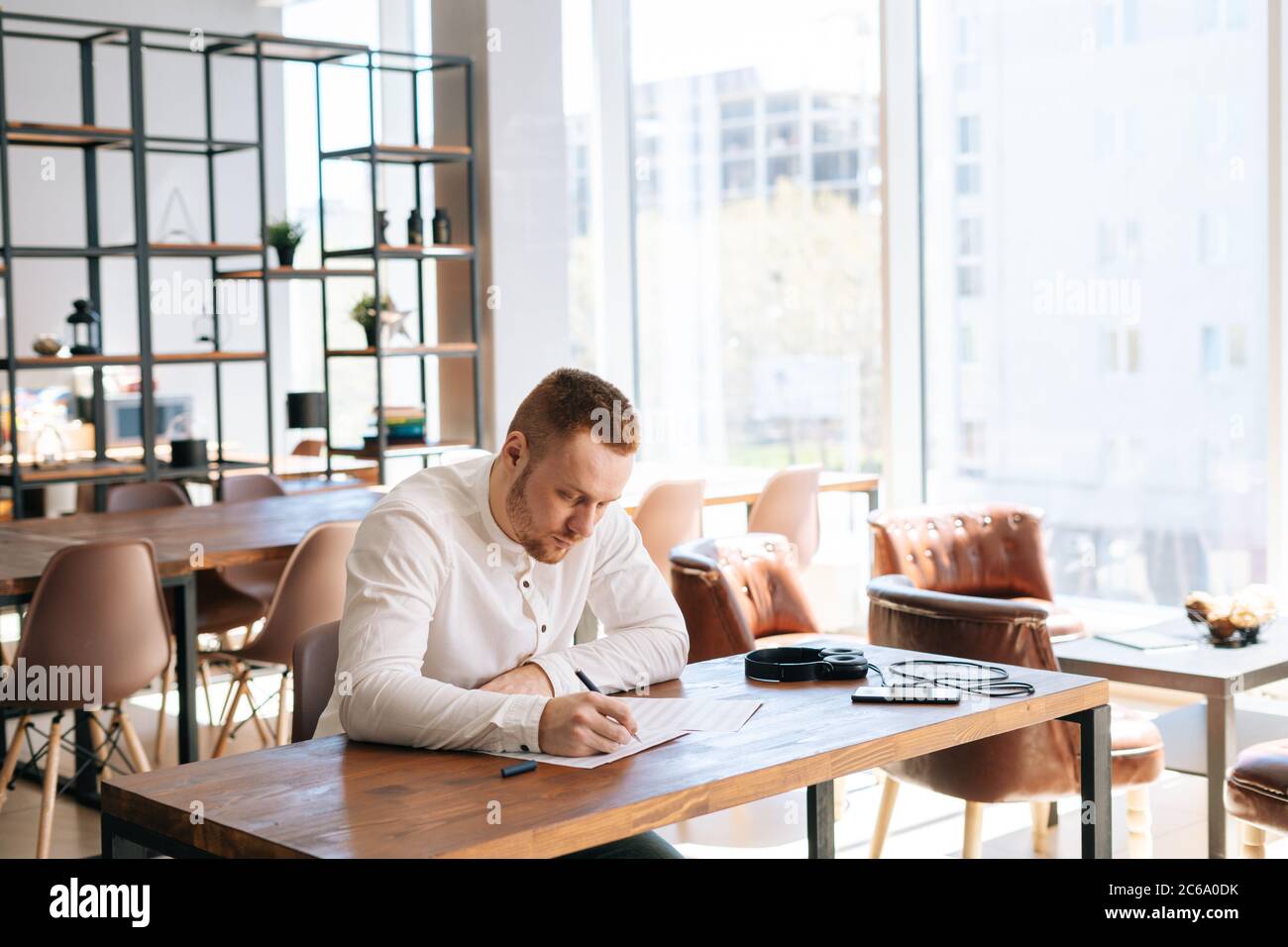 Handsome young musician man wearing casual clothing writing musical ...