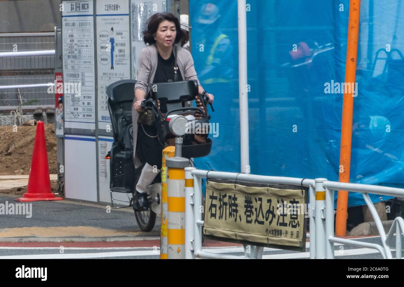 Japanese mothers riding mamachari bicycle in the street of Nakano ...
