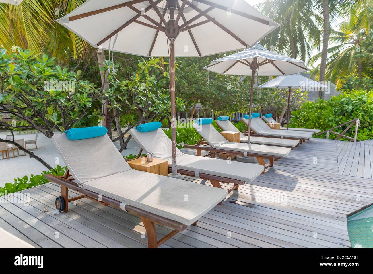 Relax concept. Cozy and comfortable sun beds and beach umbrellas near ...