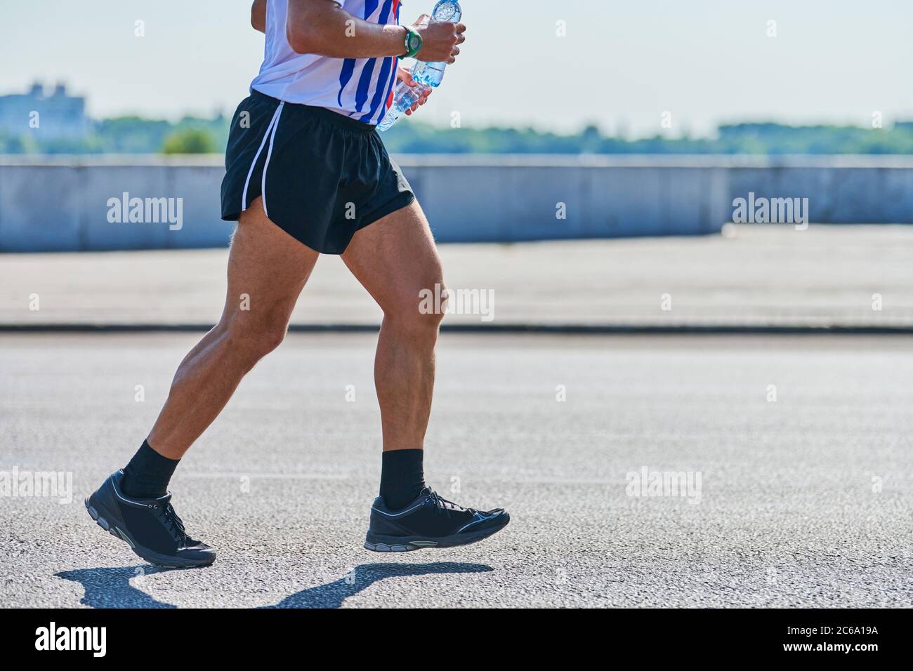Running man. Athletic man jogging in sportswear on city road. Healthy lifestyle, fitness sport ...
