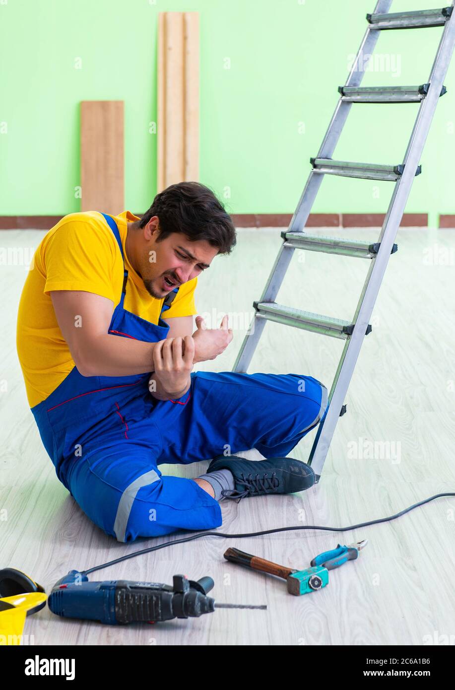 The injured worker at the work site Stock Photo - Alamy
