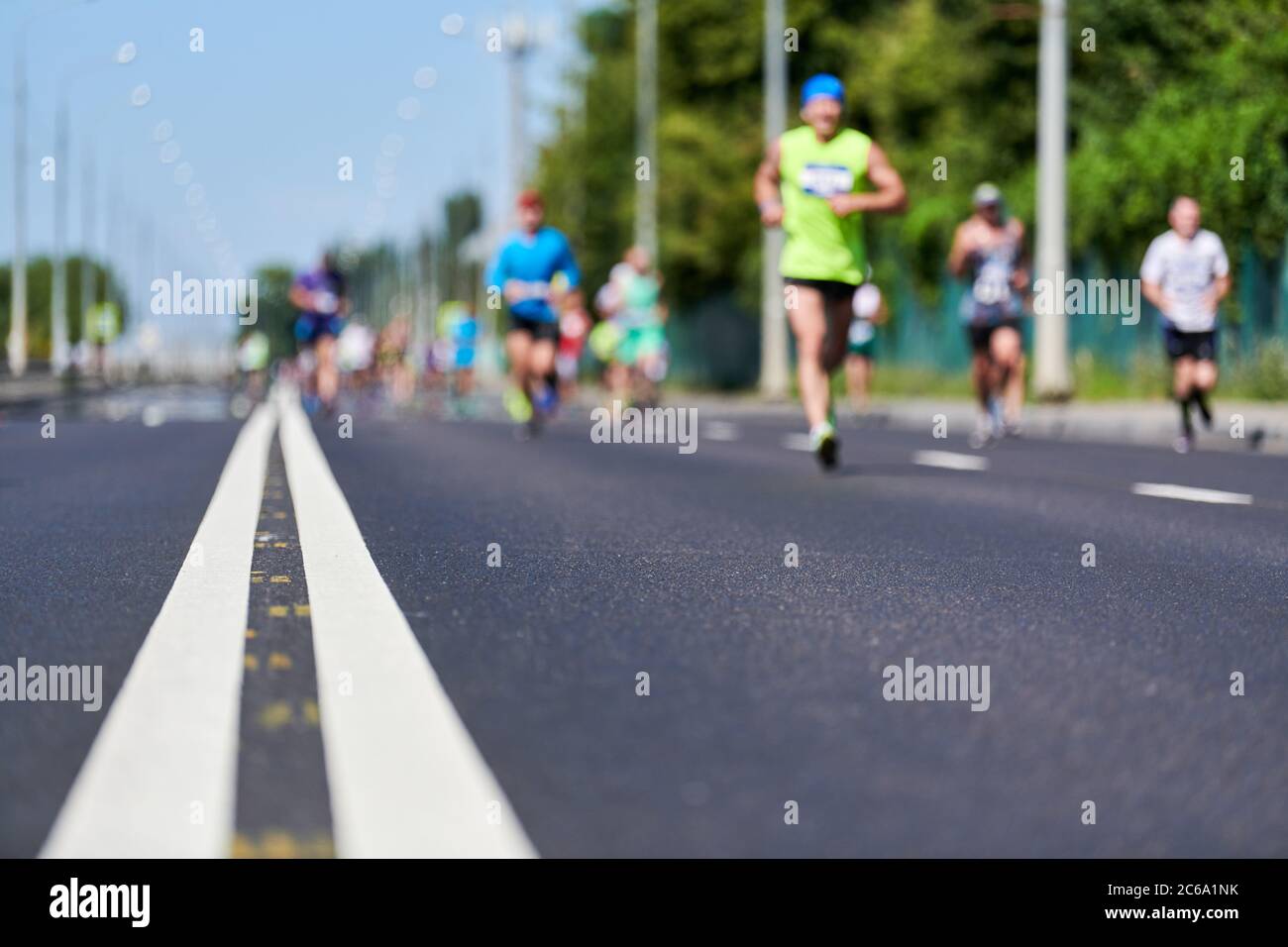 Marathon runners on city road. Running competition, copy space. Street ...