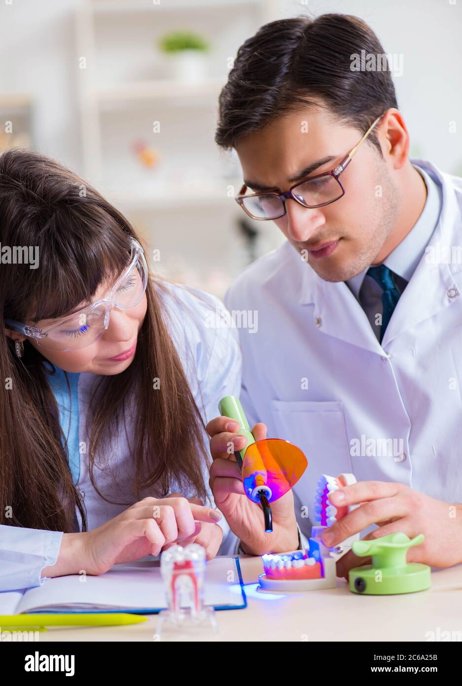 The doctor explaining to assistant how to use ultraviolet gun Stock ...