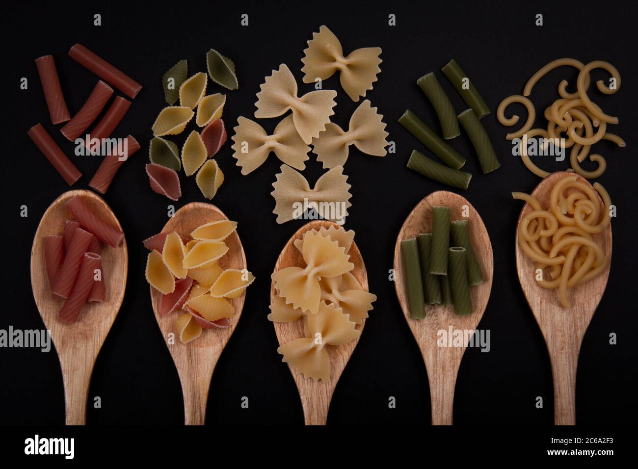Shaped and colorful pasta in different sizes and colors in small dishes ...