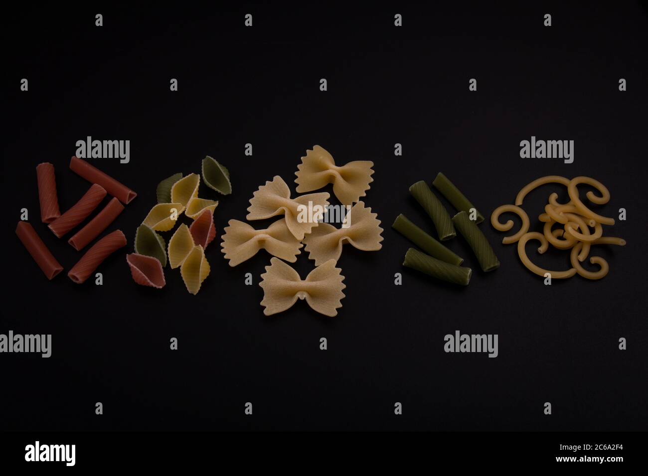Shaped and colorful pasta in different sizes and colors in small dishes ...