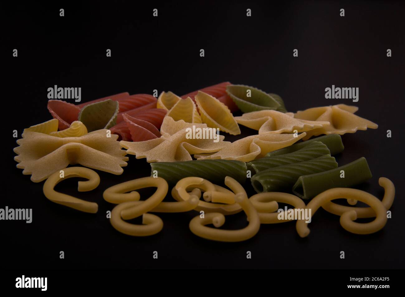 Shaped and colorful pasta in different sizes and colors in small dishes ...