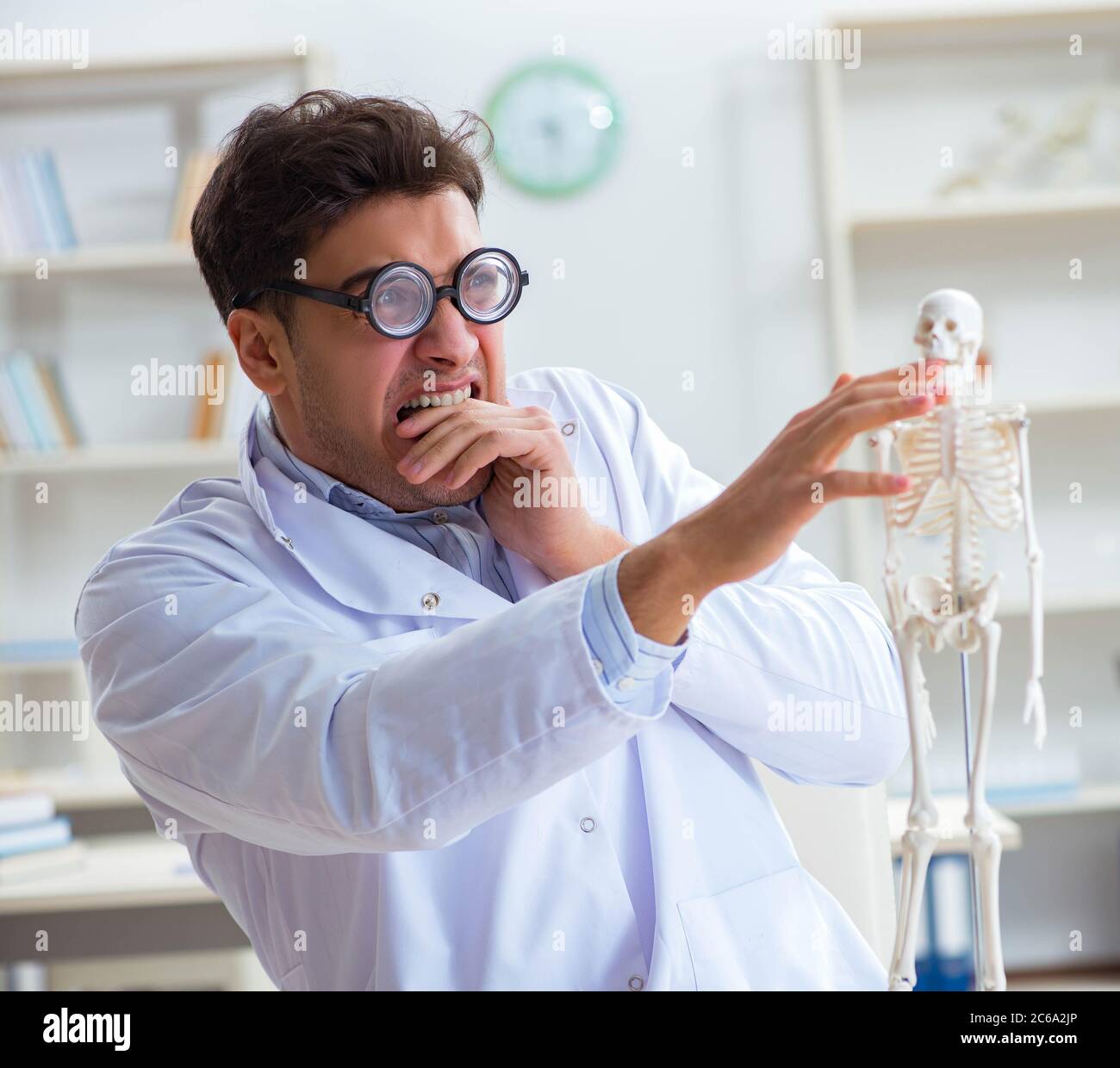 The crazy doctor studying human skeleton Stock Photo - Alamy