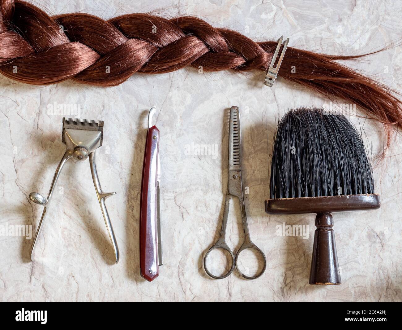 Tool in hairdressing craft vintage with red hair braid Stock Photo - Alamy