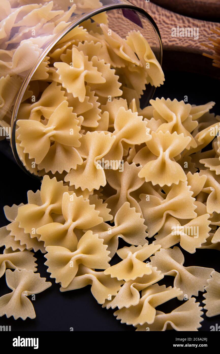 Shaped and colorful pasta in different sizes and colors in small dishes ...