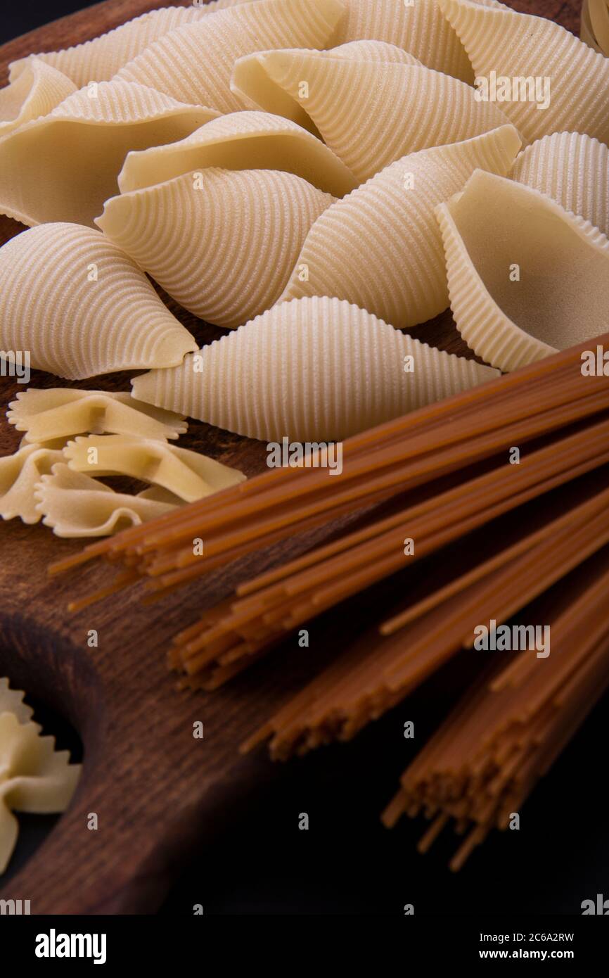 Shaped pasta and plain pasta. Pasta in different shapes and colors with ...