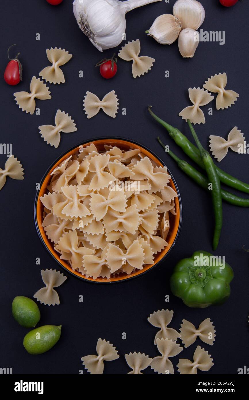 Shaped and colorful pasta in different sizes and colors in small dishes ...