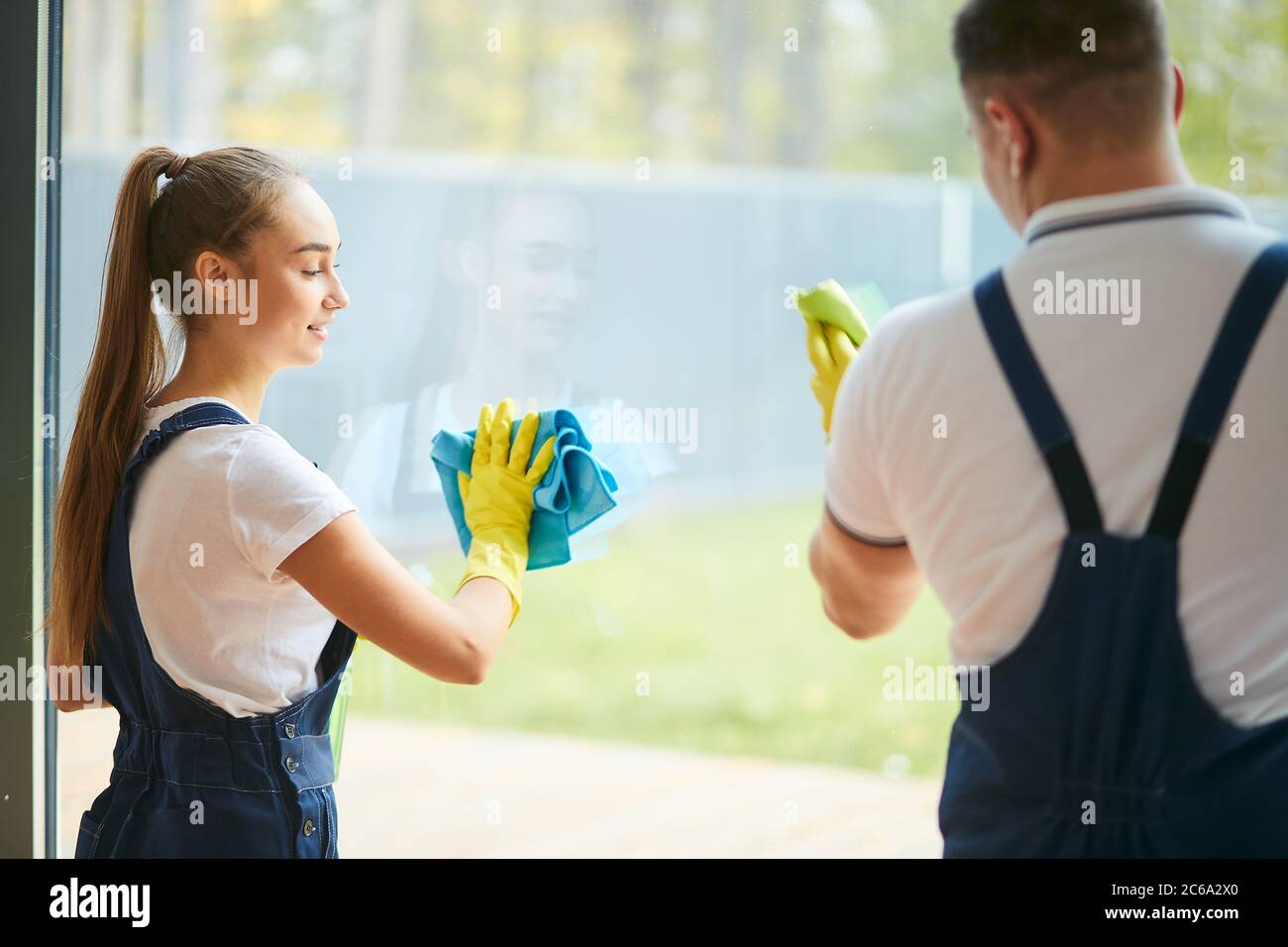 Cleaning service concept. Rear view on two workers of cleaning company ...