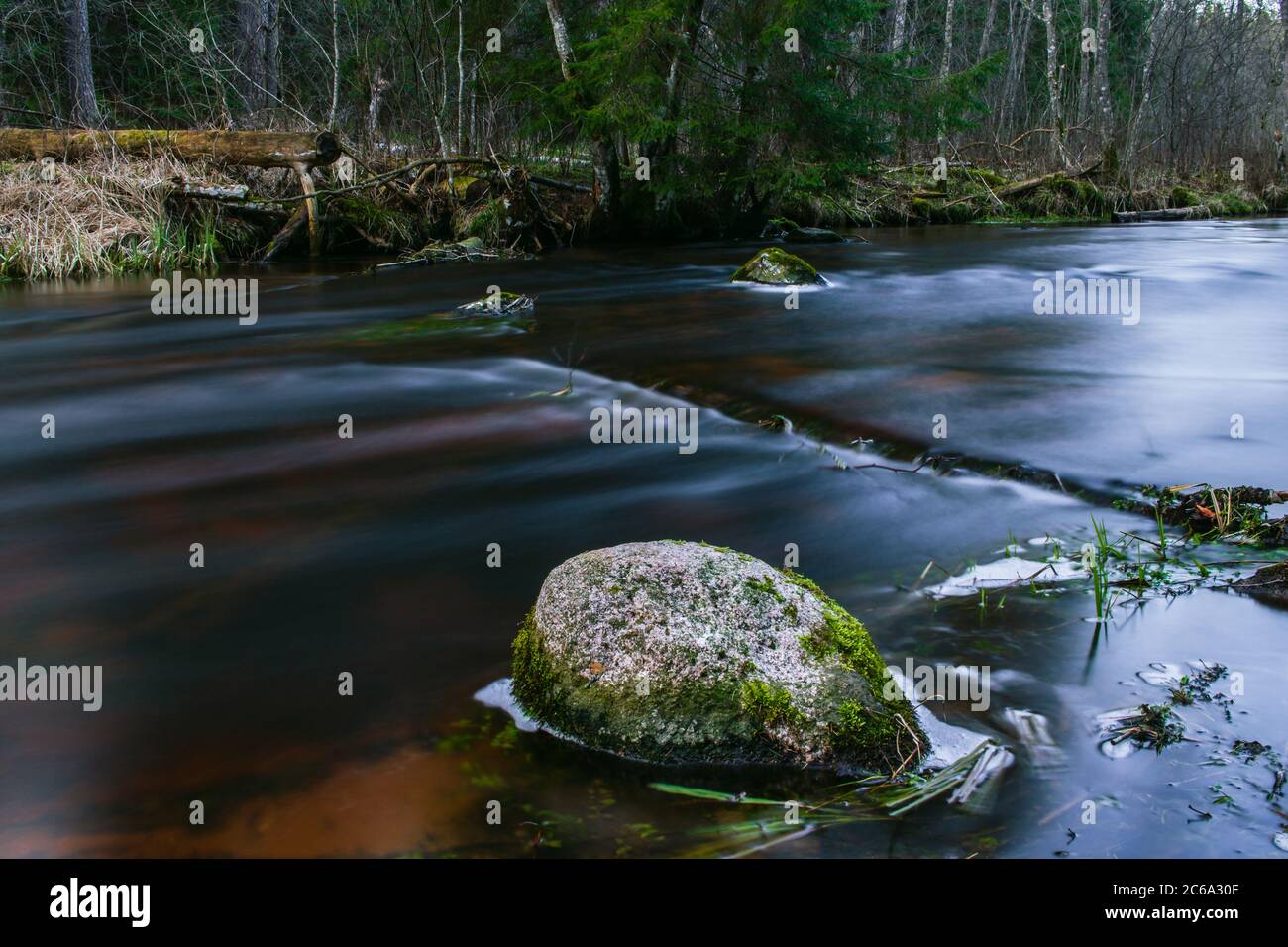 Dark river water rock Stock Photo - Alamy