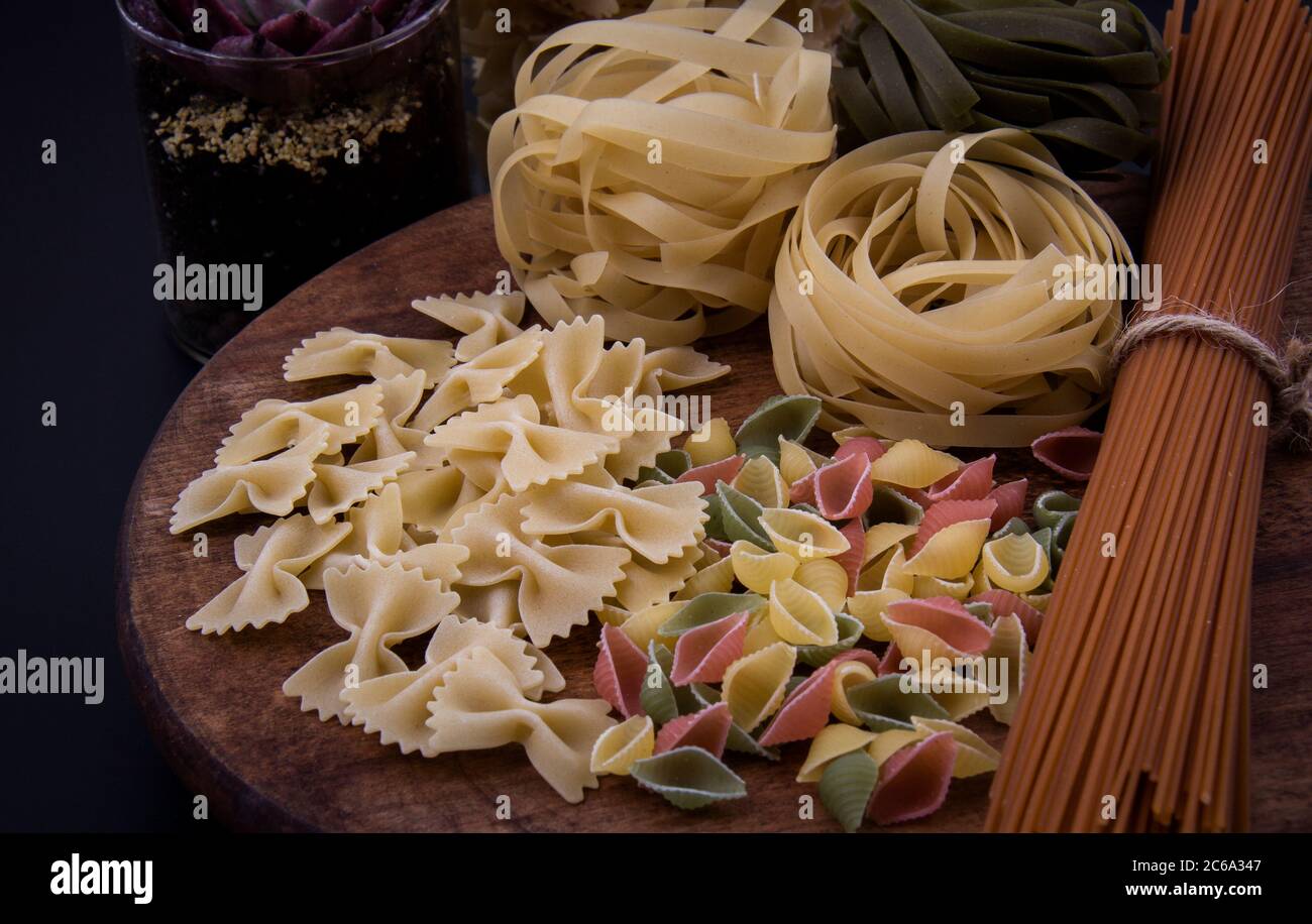 Shaped pasta and plain pasta. Pasta in different shapes and colors with ...