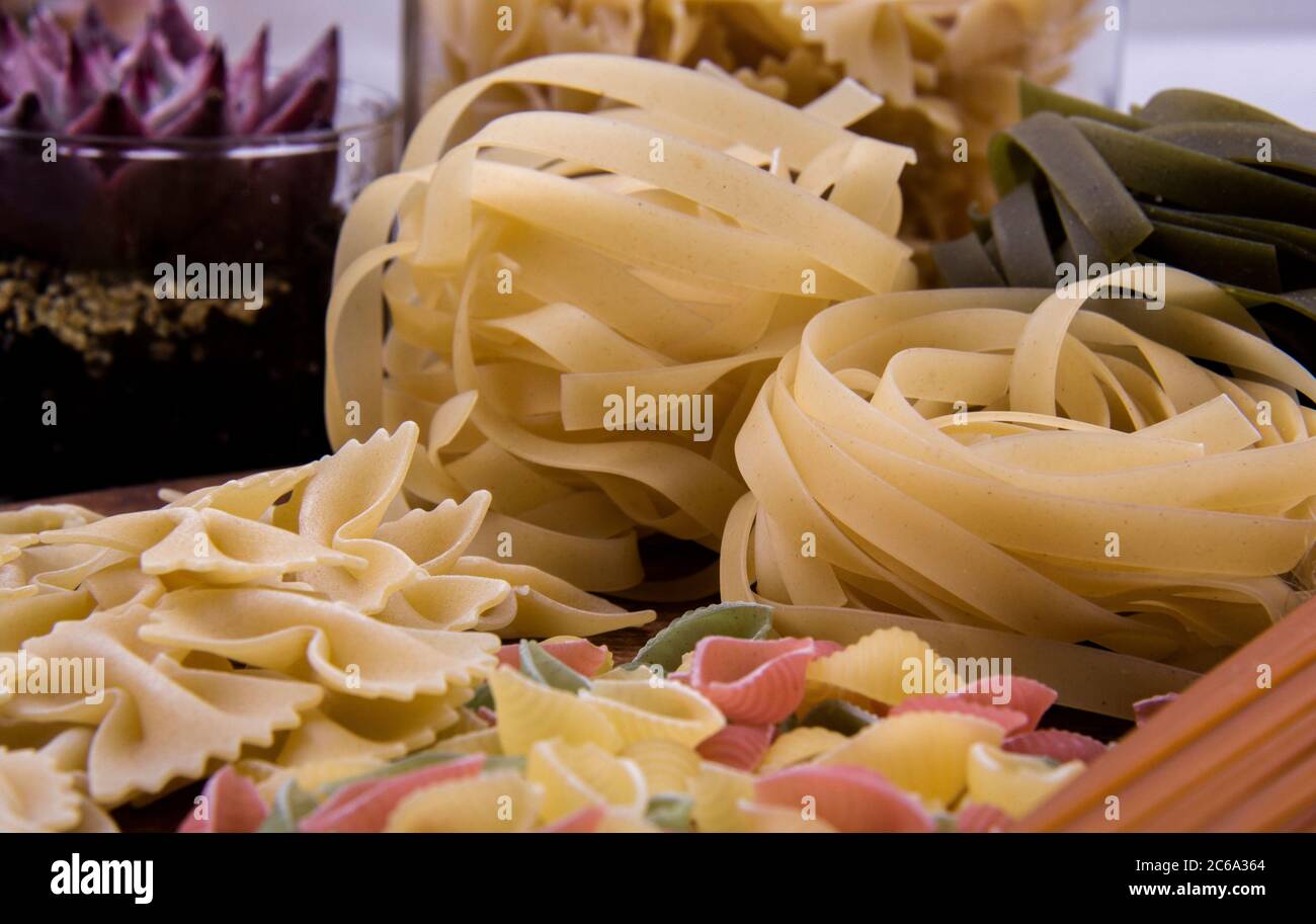 Shaped and colorful pasta in different sizes and colors in small dishes ...