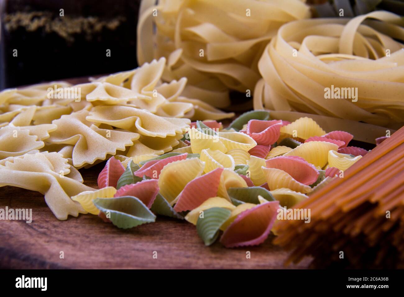 Shaped pasta and plain pasta. Pasta in different shapes and colors with ...