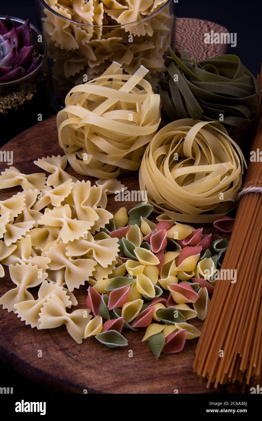 Shaped pasta and plain pasta. Pasta in different shapes and colors with ...