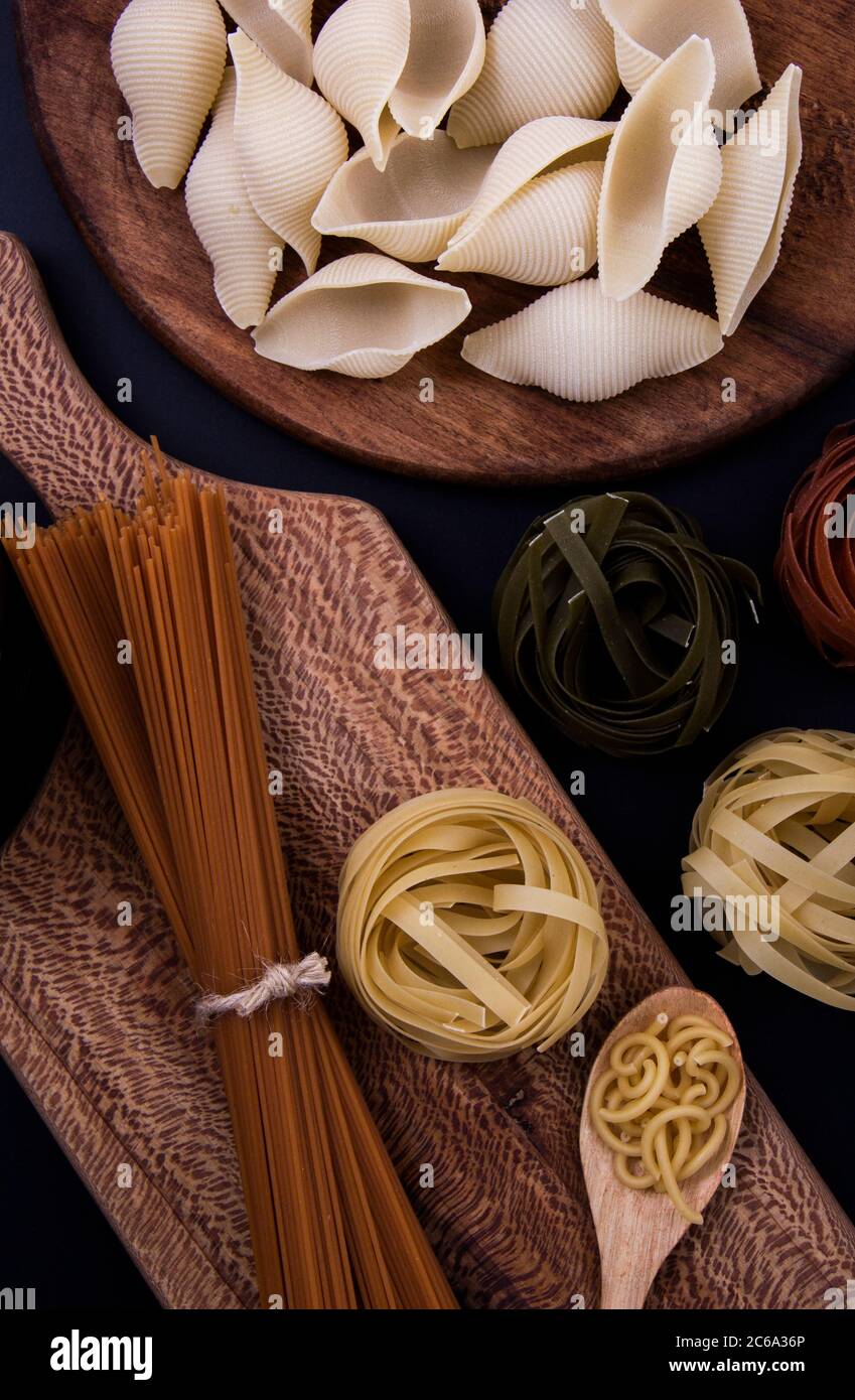 Shaped pasta and plain pasta. Pasta in different shapes and colors with ...