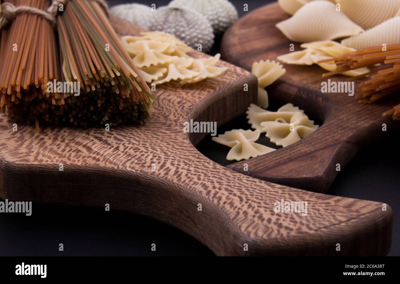 Shaped pasta and plain pasta. Pasta in different shapes and colors with ...