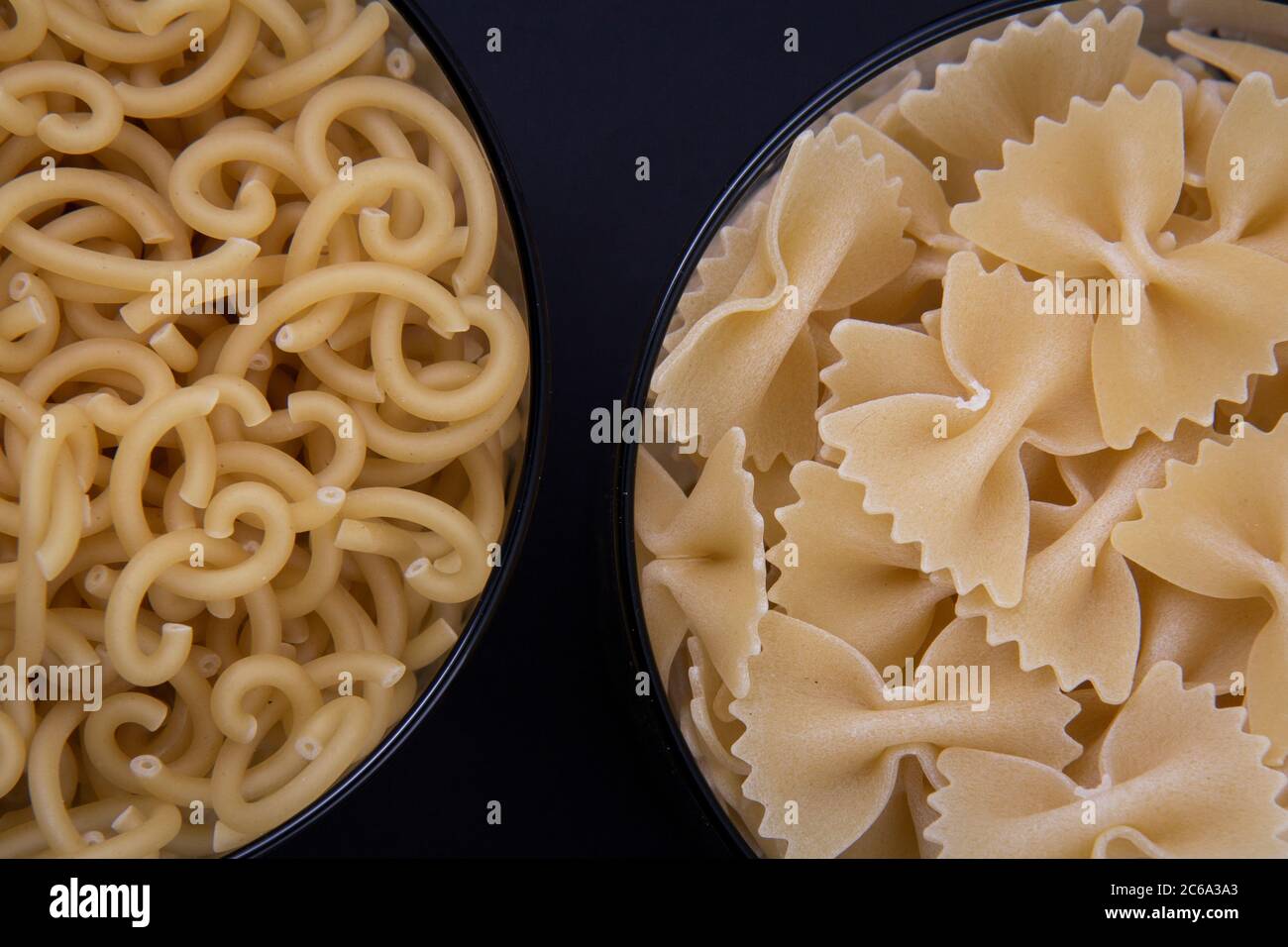 Shaped and colorful pasta in different sizes and colors in small dishes ...
