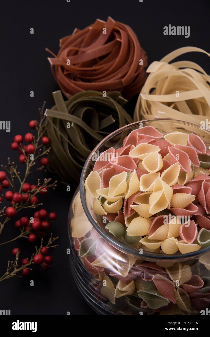 Shaped and colorful pasta in different sizes and colors in small dishes ...