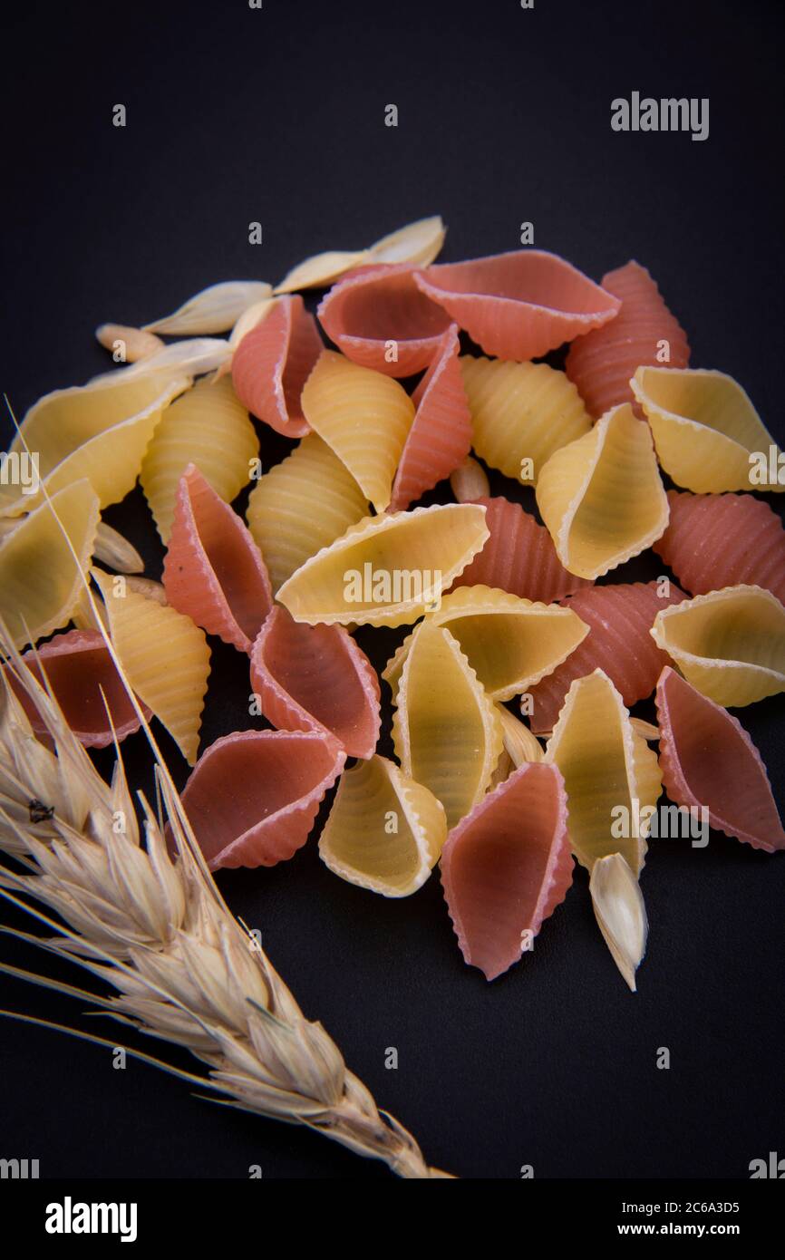 Shaped and colorful pasta in different sizes and colors in small dishes ...