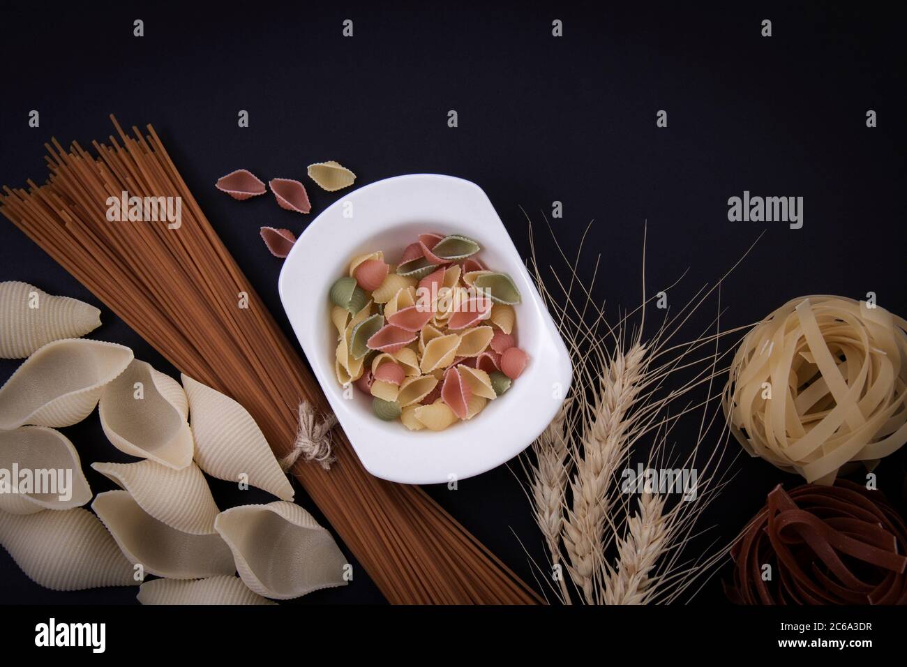 Shaped pasta and plain pasta. Pasta in different shapes and colors with ...
