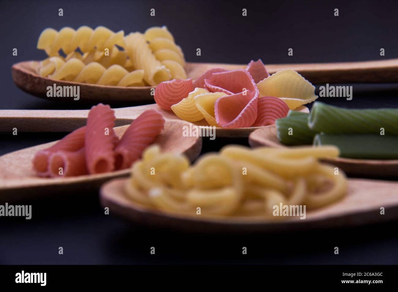 Shaped and colorful pasta in different sizes and colors in small dishes ...