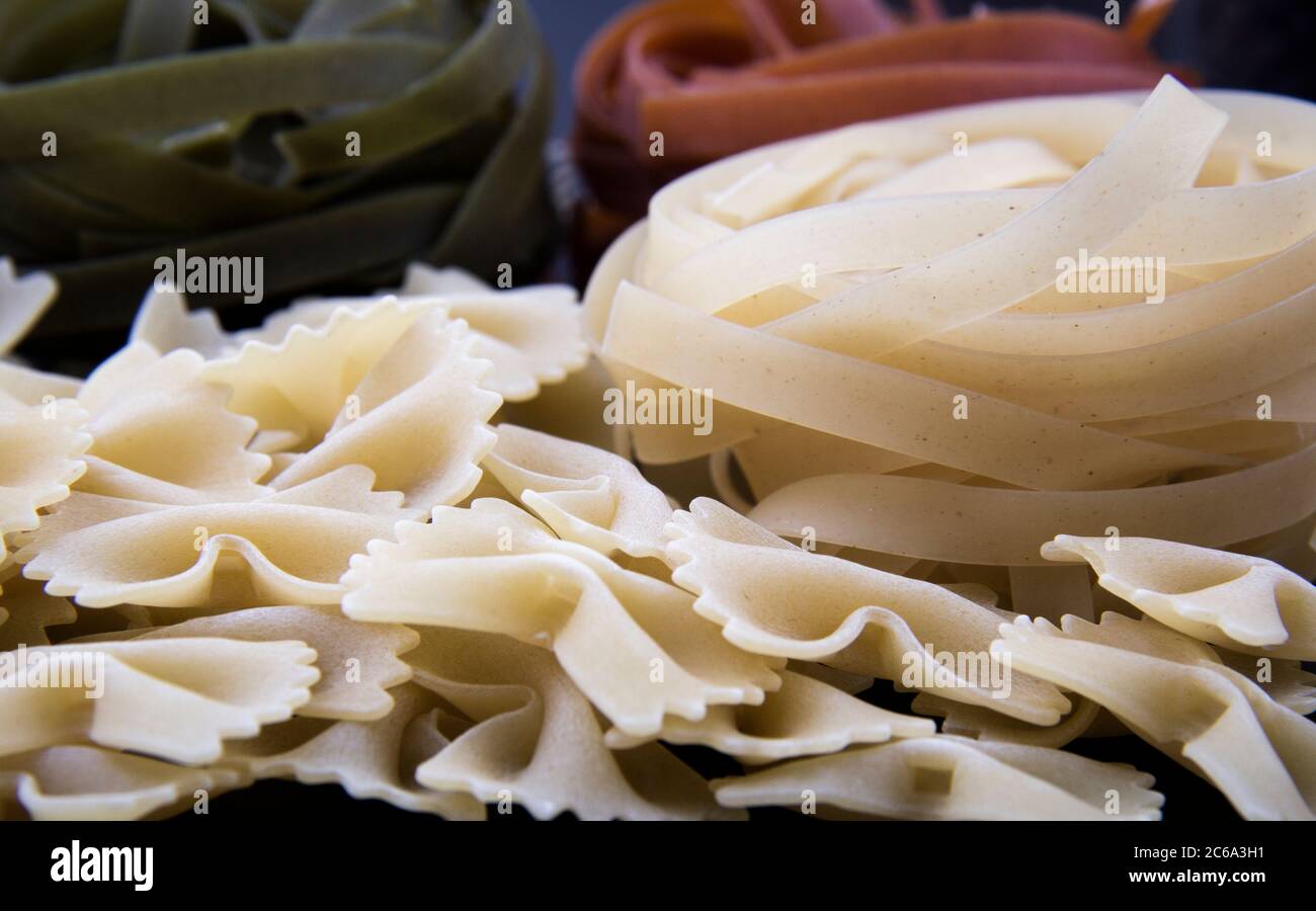 Shaped and colorful pasta in different sizes and colors in small dishes ...