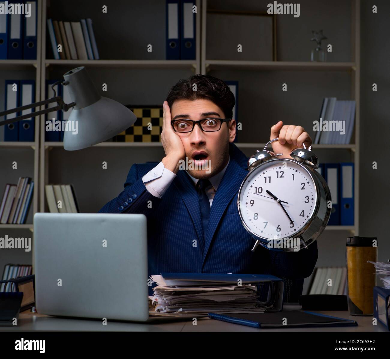 The employee staying late to finish work on auditing Stock Photo - Alamy