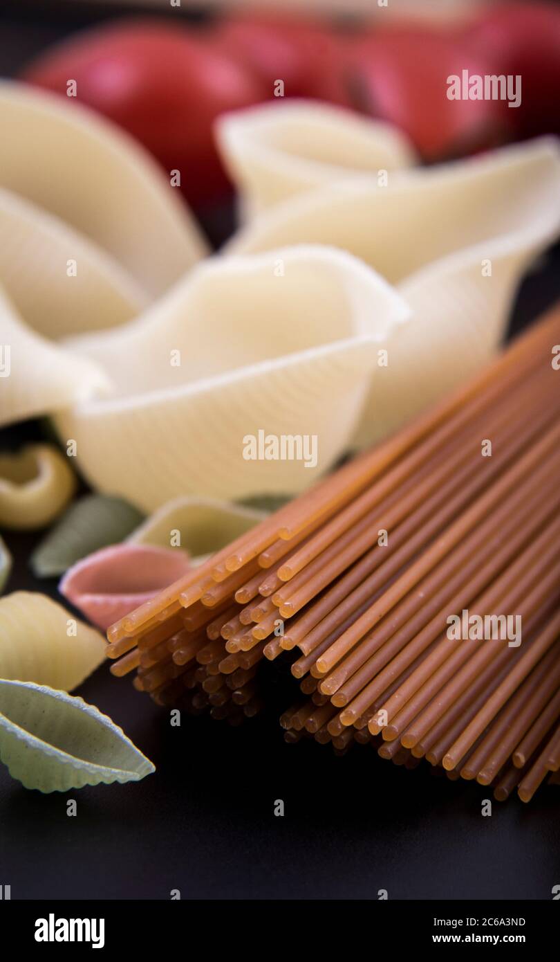 Shaped pasta and plain pasta. Pasta in different shapes and colors with ...