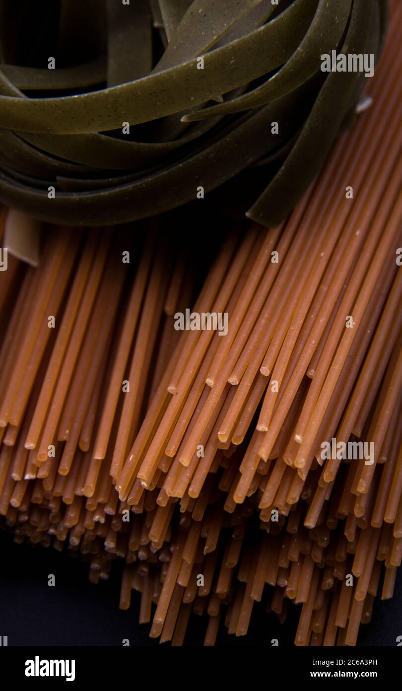 Shaped pasta and plain pasta. Pasta in different shapes and colors with ...
