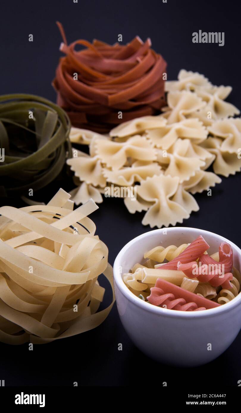 Shaped and colorful pasta in different sizes and colors together from ...