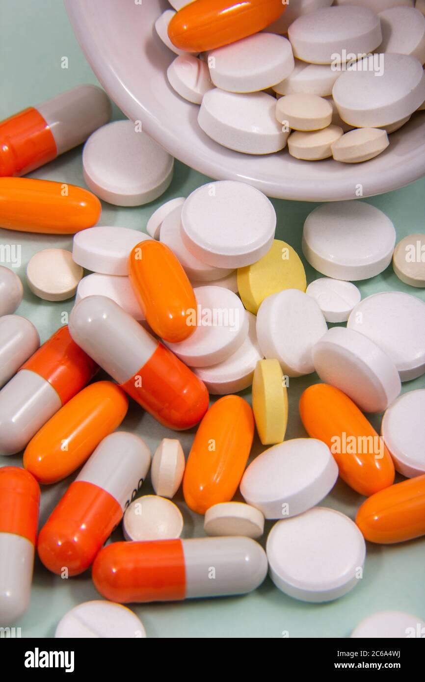 See colorful tablets and capsules from above in a bowl Stock Photo - Alamy