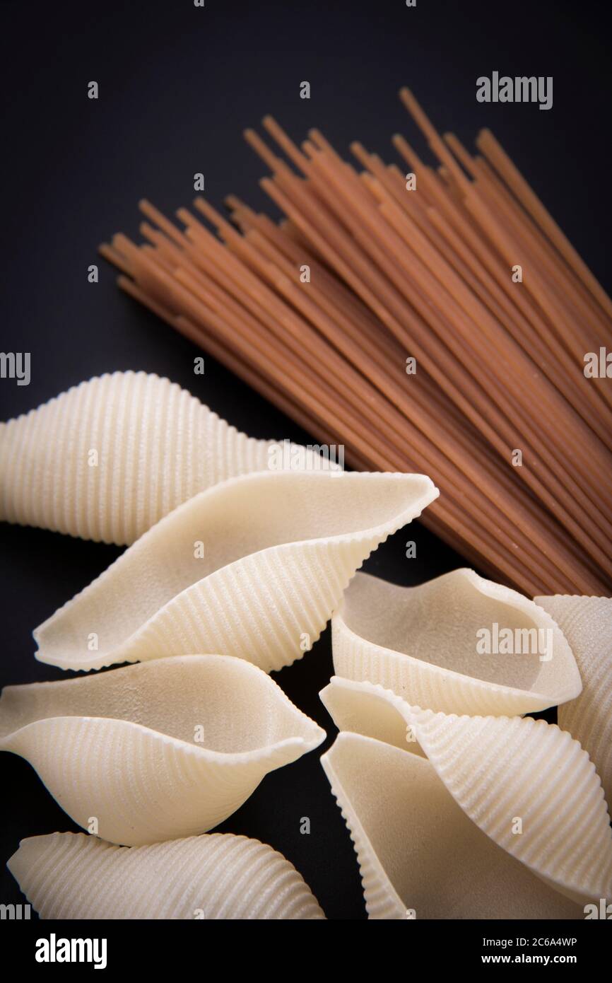 Shaped pasta and plain pasta. Pasta with different shapes and colors ...