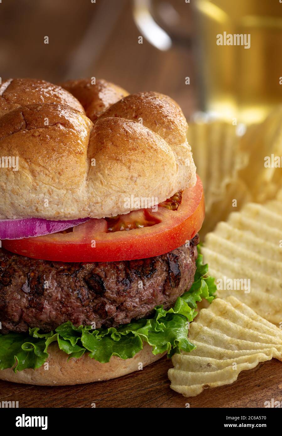 Juicy grilled hamberger with lettuce, tomato and onions on whole grain ...
