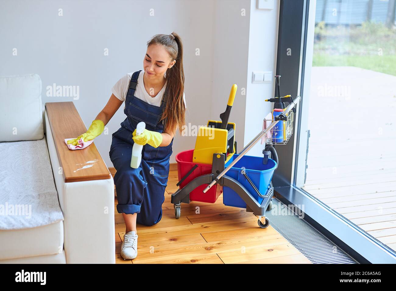 Diligent and careful woman in blue uniform pay attention to little ...